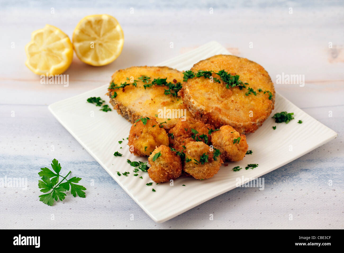 Fried hake with breaded mushrooms. Recipe available Stock Photo - Alamy