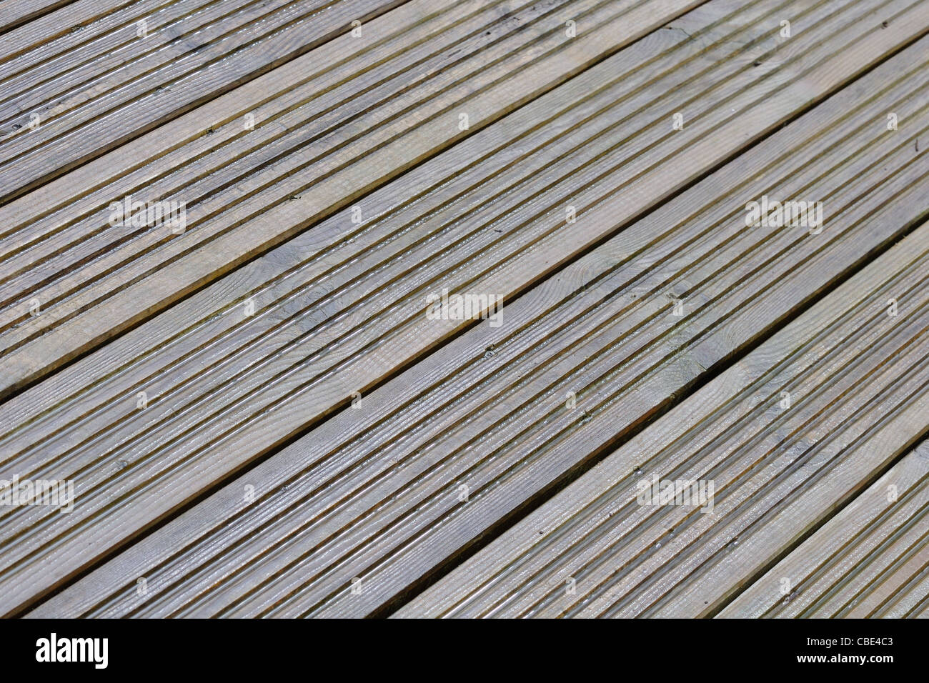 Wet wooden decking boards Stock Photo - Alamy