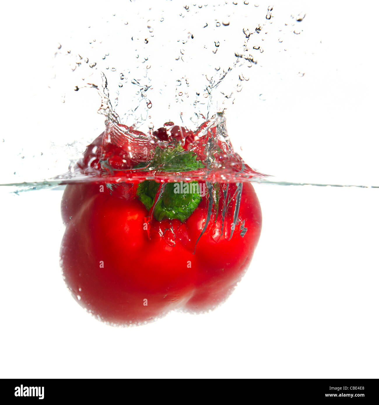 Splashing red paprika in bright water Stock Photo - Alamy