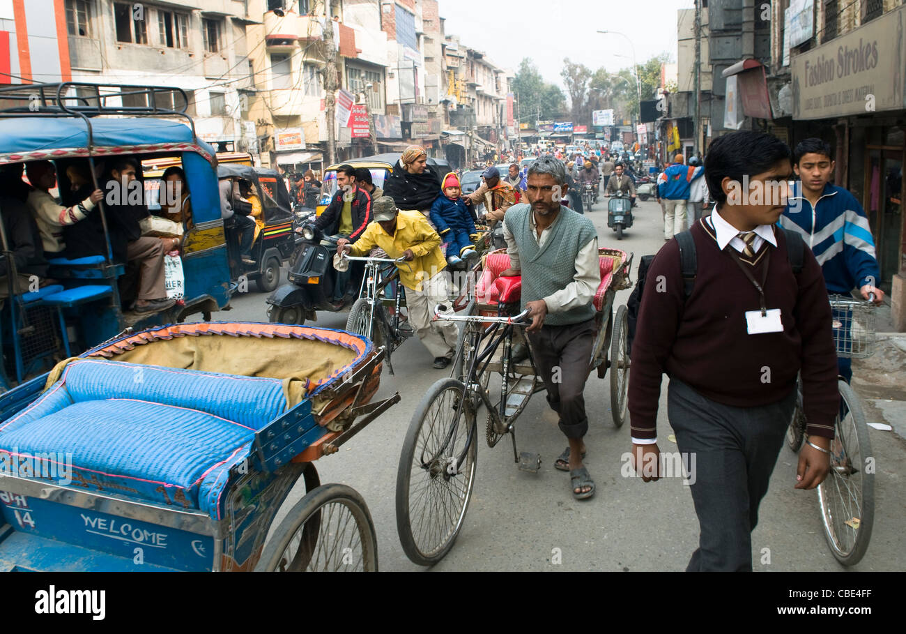 Busy street packed with cycle rickshaws and people is a common scene in ...
