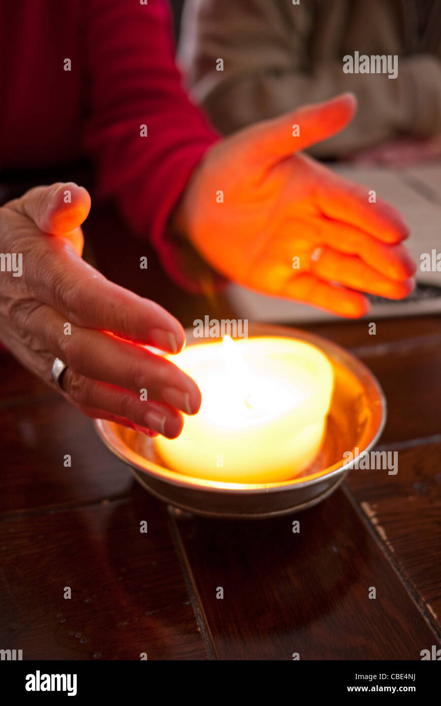 Warming hands candle hi-res stock photography and images - Alamy