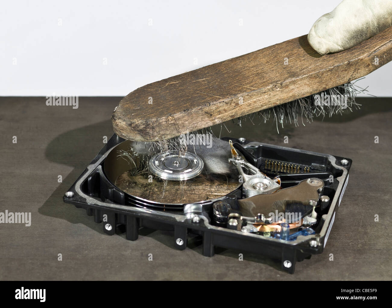 scrubbing a dard disk on metallic ground Stock Photo - Alamy