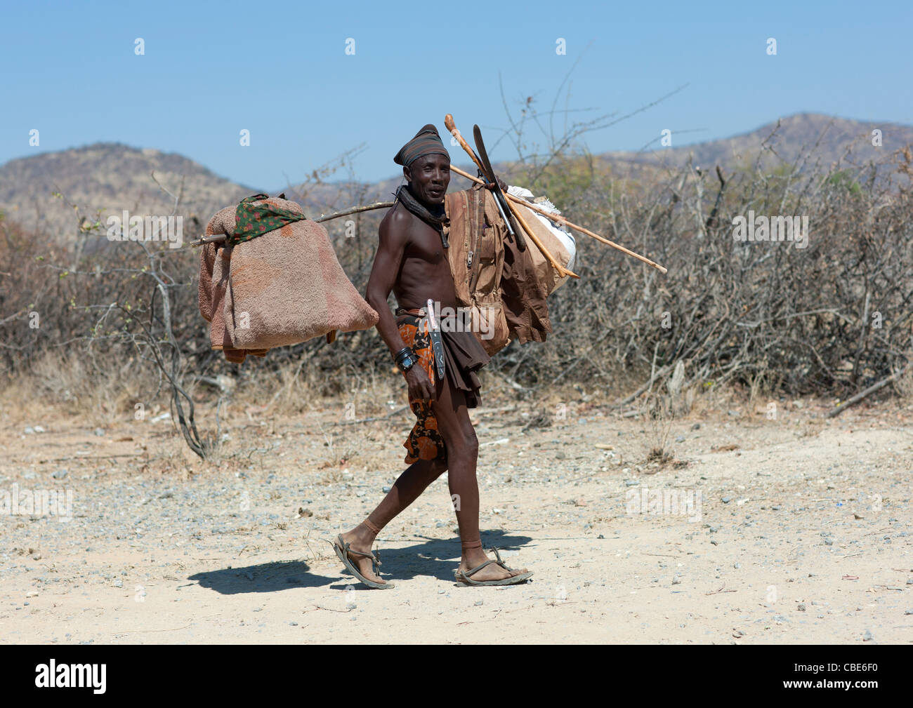 Muhimba Man Carrying Clothes On A Stick, Village Of Elola, Angola Stock ...