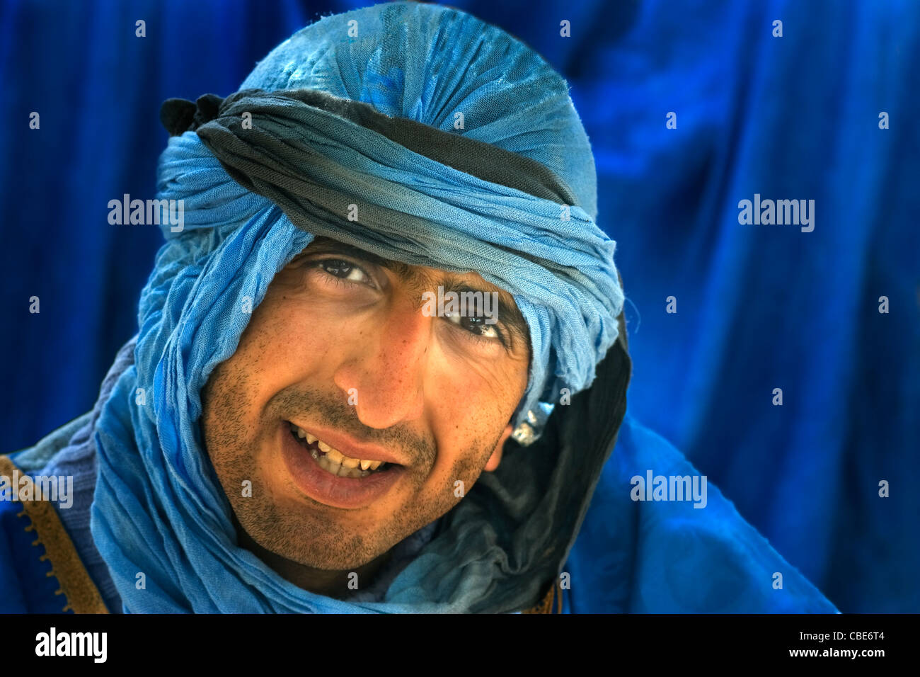 A portrait of a young adult male Moroccan man in traditional blue Arab ...