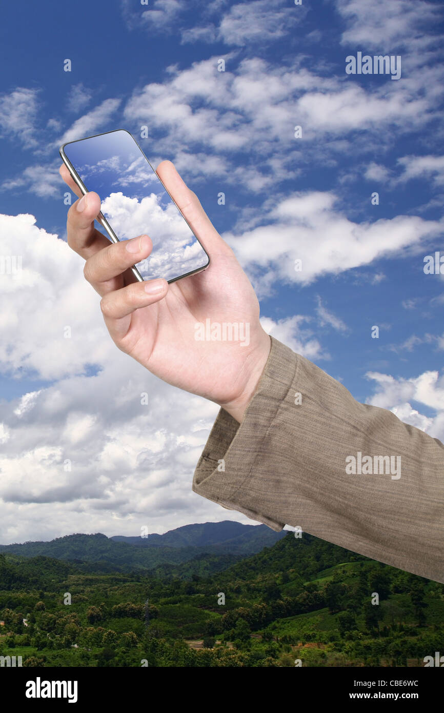 Businessman holding his mobile phone on cloud Stock Photo - Alamy