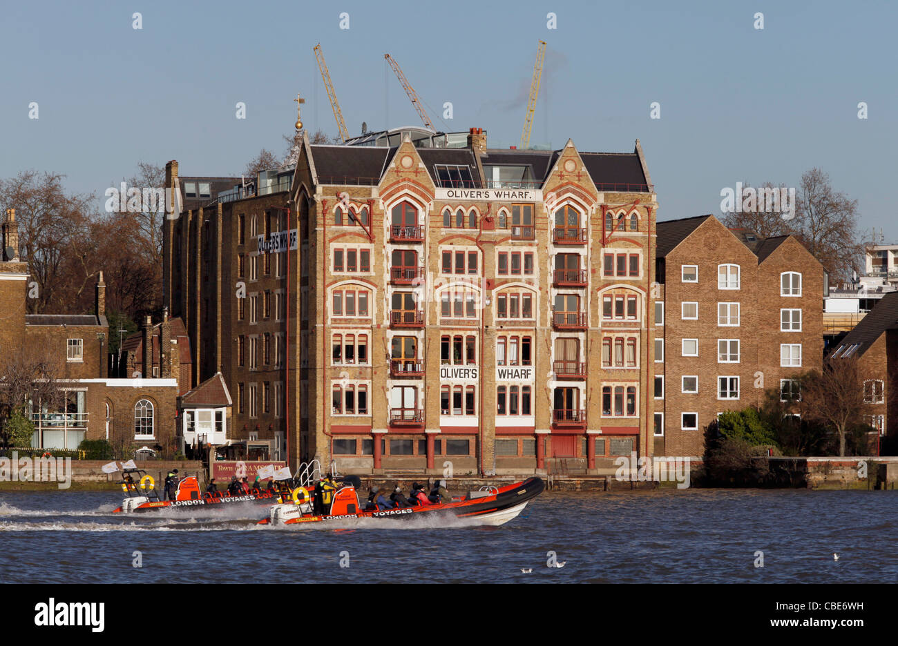 Speed boats sail past Wapping on Thames river in London, England, UK ...
