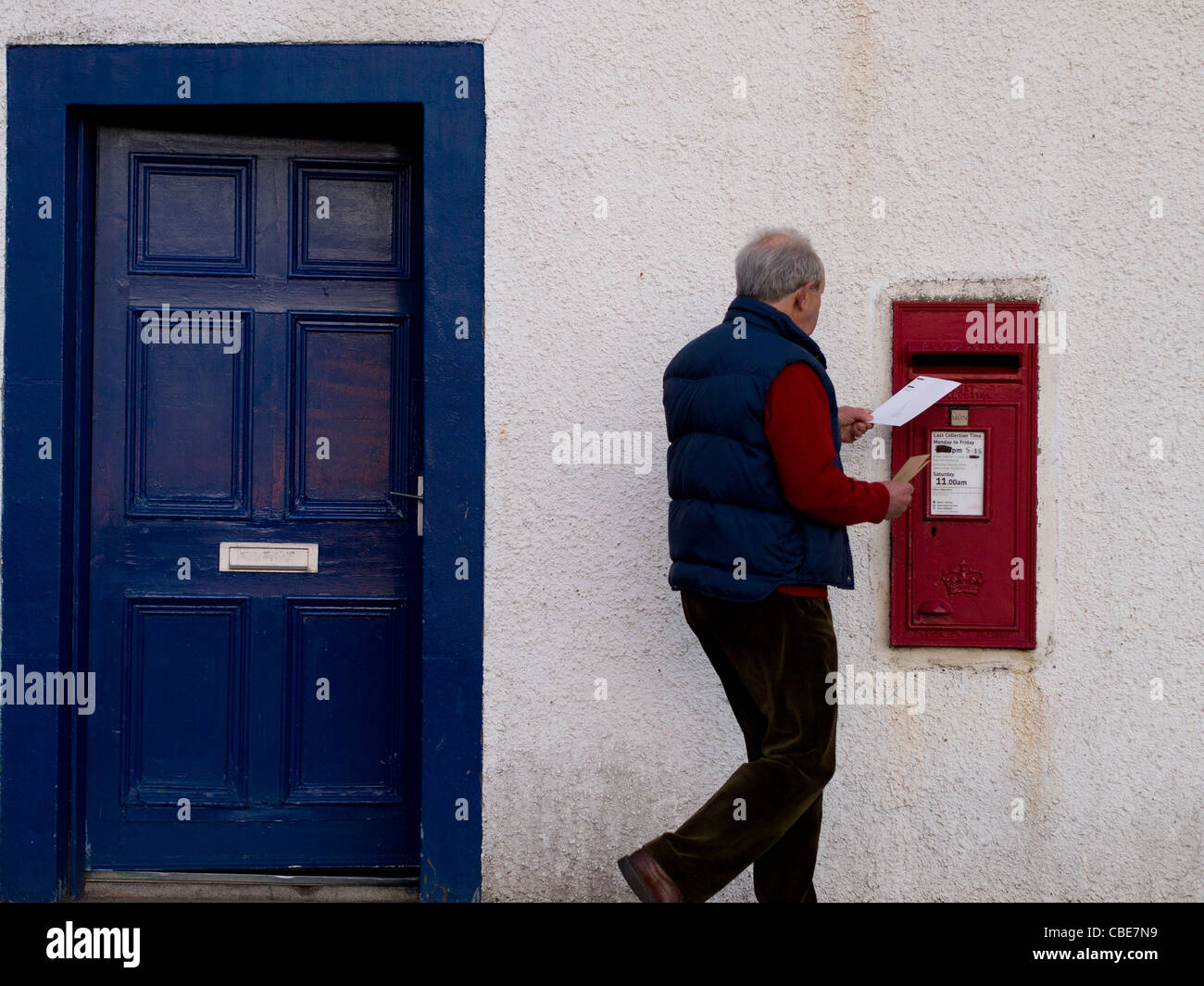 Man Posting a Letter in Post Box, St Monans, Fife Stock Photo - Alamy