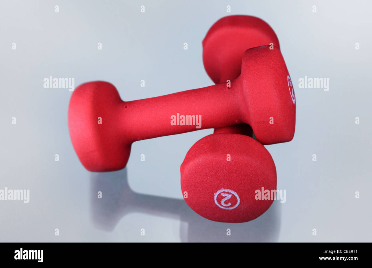 two red hand weights, high key Stock Photo - Alamy