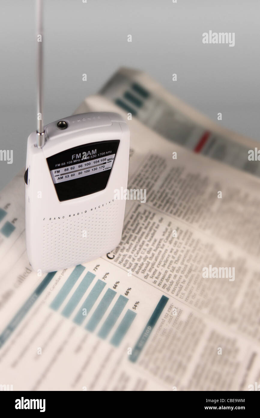 a portable radio placed on a newspaper's business section Stock Photo ...
