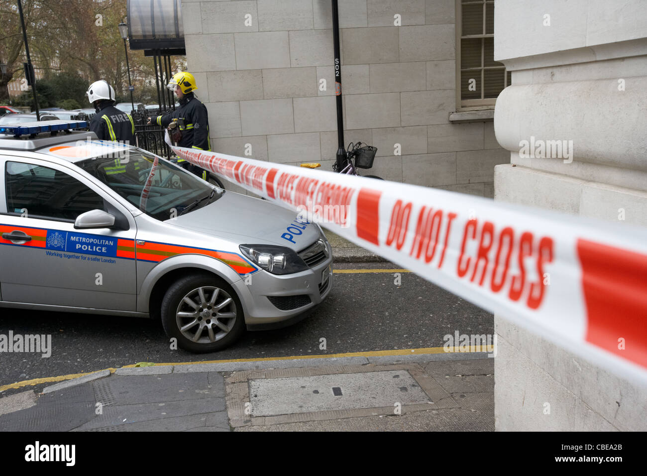 fire brigade and metropolitan police squad car with police inner cordon ...