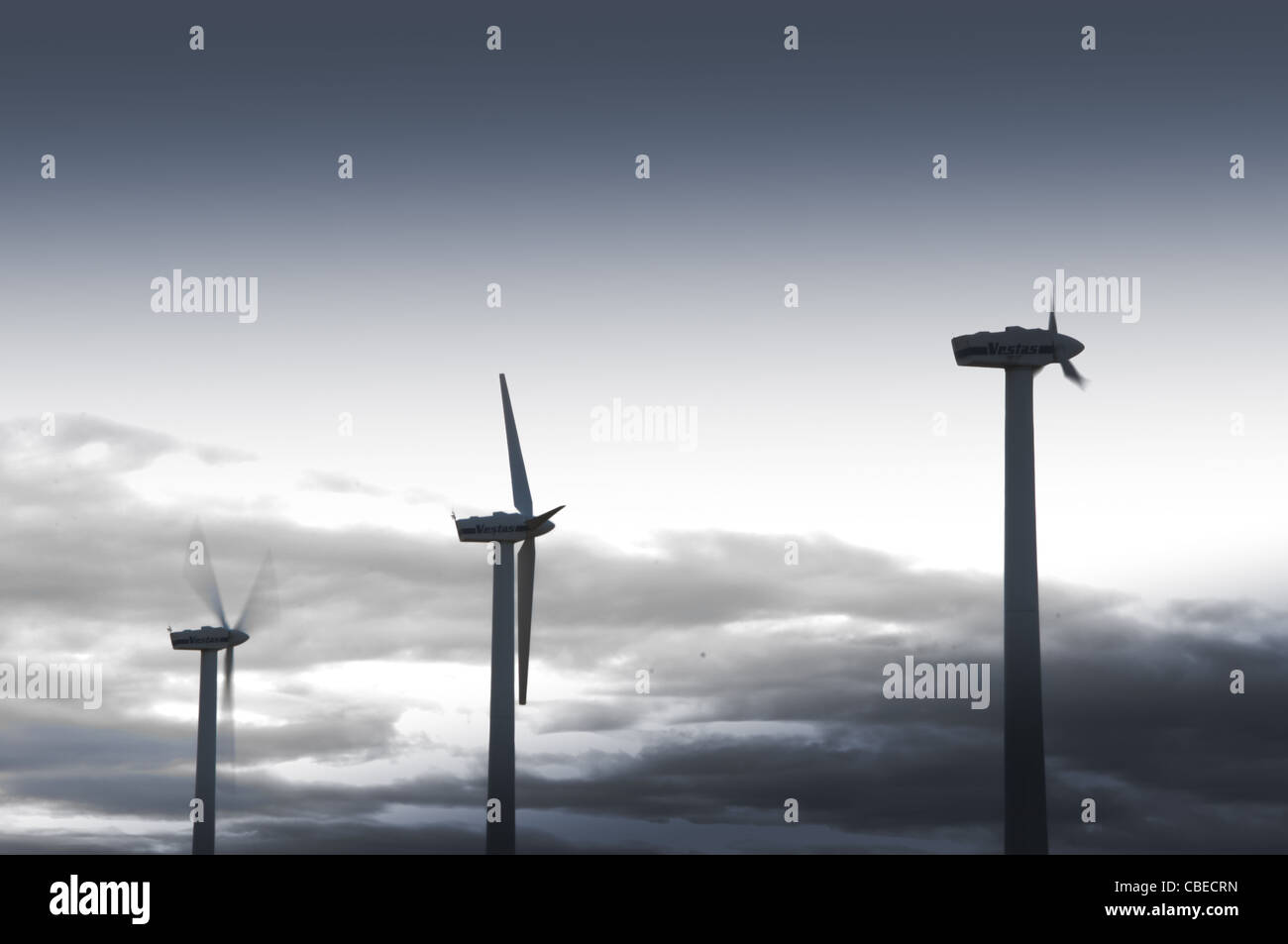 Wind turbines against the light one stopped Stock Photo - Alamy