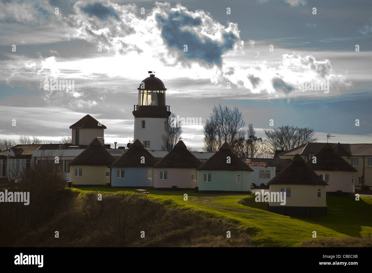 Hermanus round thatched holiday cottages with lighthouse Stock Photo ...