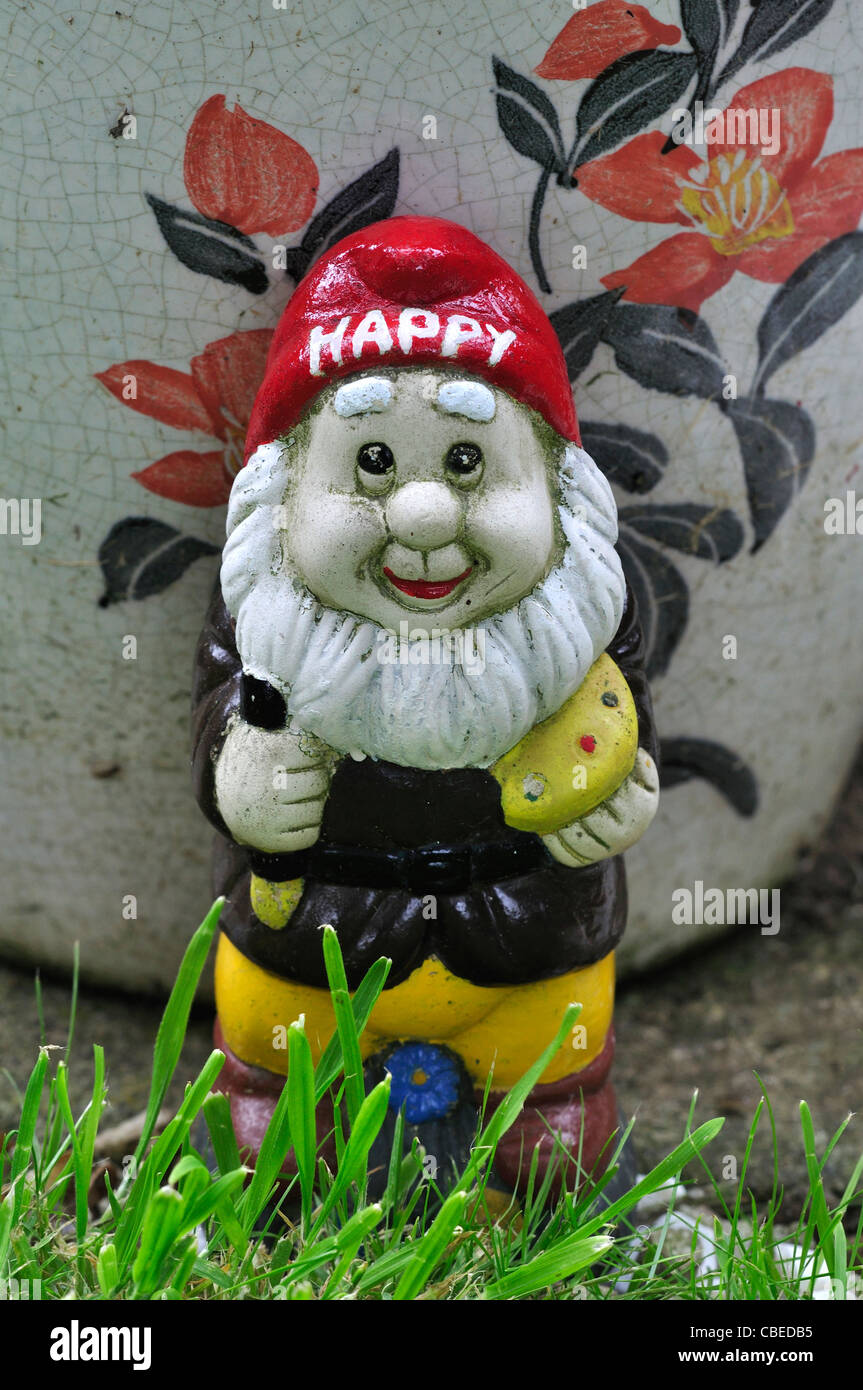 One of the seven dwarves - Happy - sitting in a garden UK Stock Photo ...