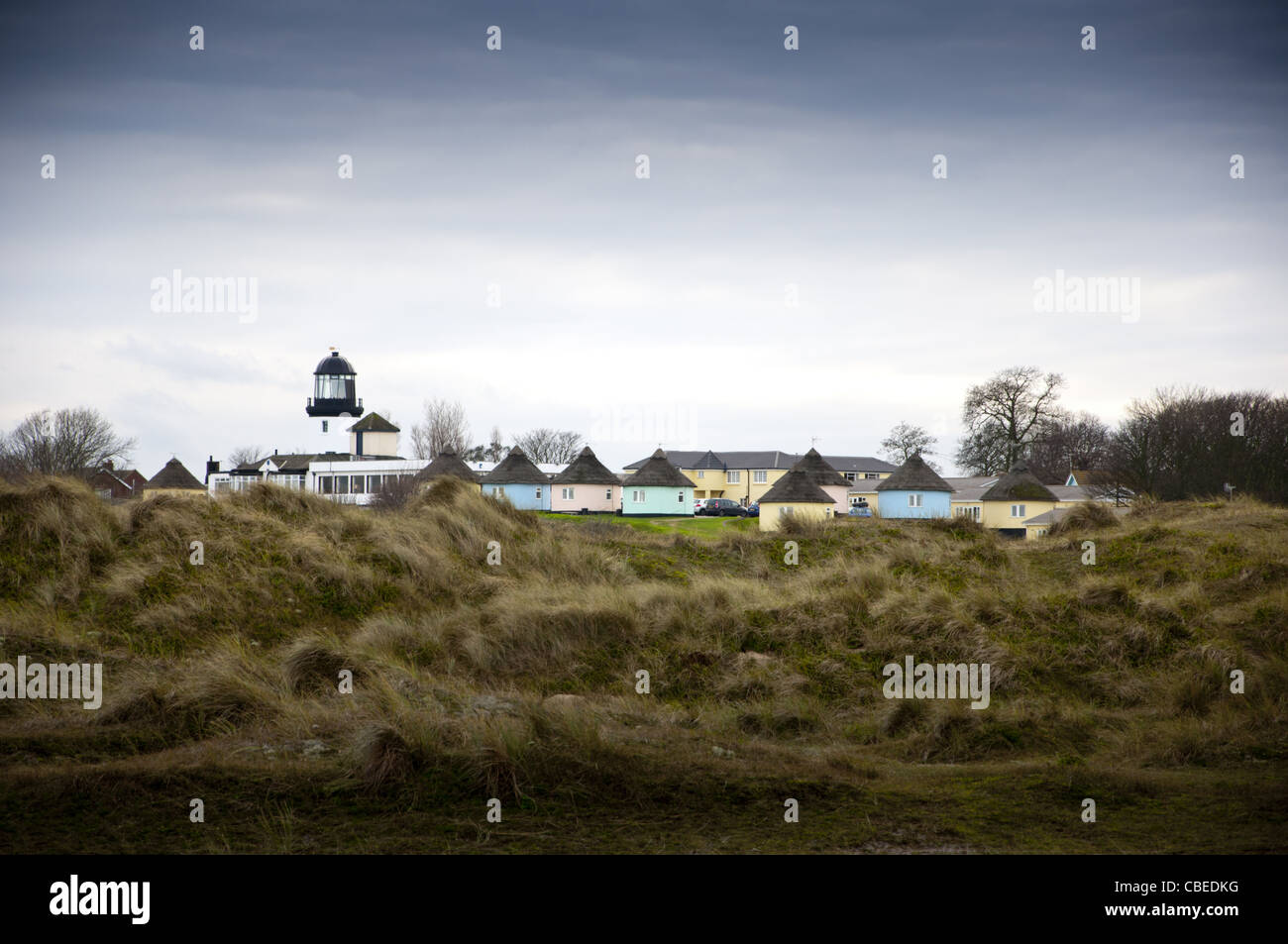Hermanus round thatched holiday cottages with lighthouse Stock Photo ...
