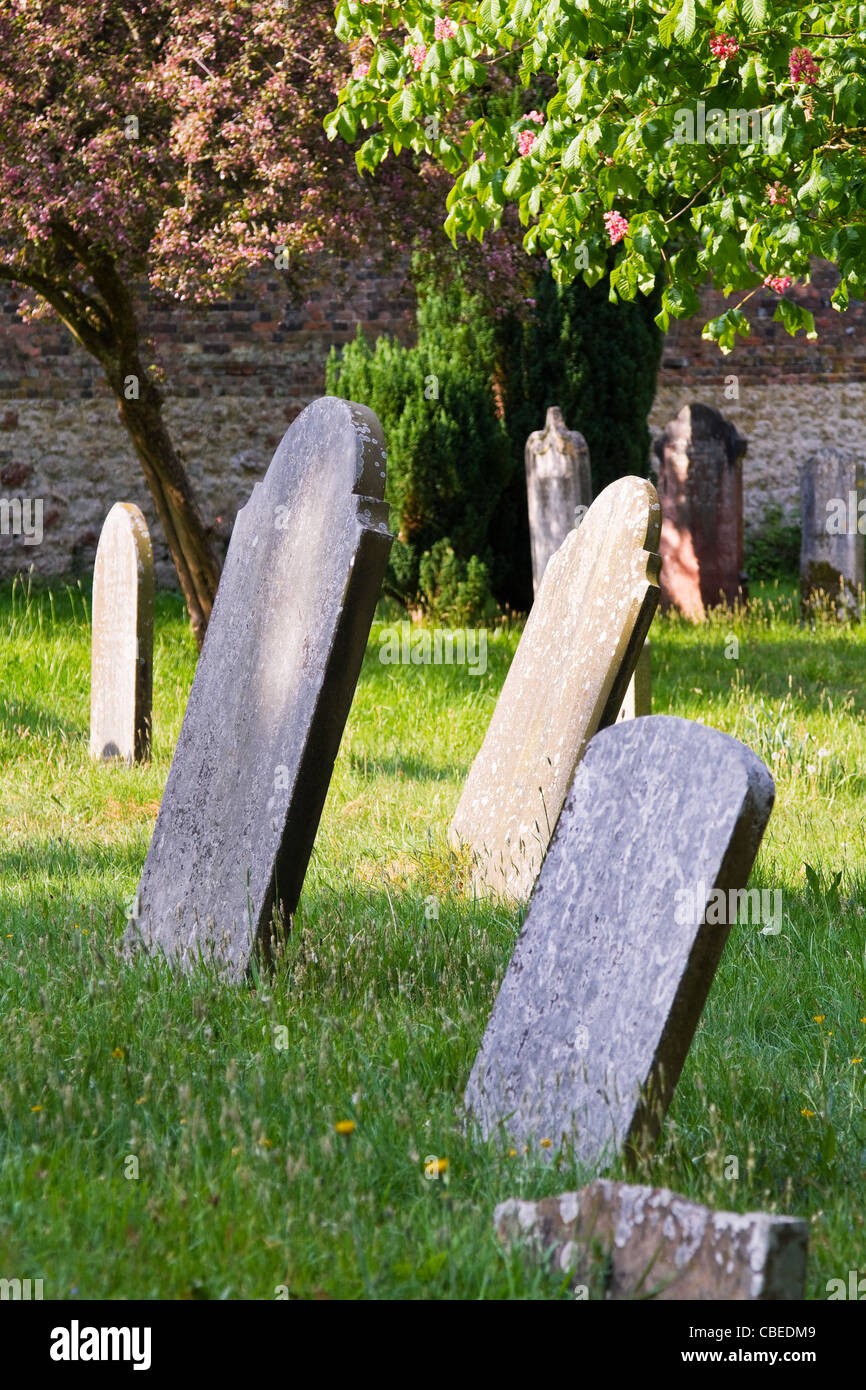 Old gravestones in a country cemetery leaning over Stock Photo - Alamy