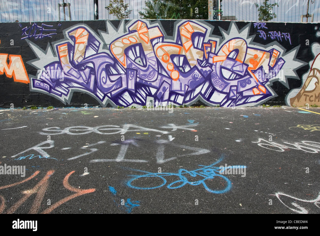 Graffiti Art Mural on Wall and Scribbled Tags on Tarmac Ground of ...