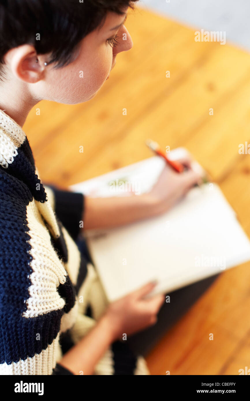 Girl writing in diary Stock Photo - Alamy