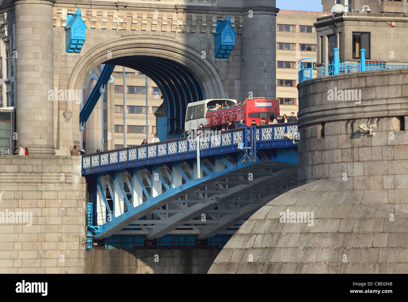 An open topped bus driving tourists across Tower Bridge, London, UK ...