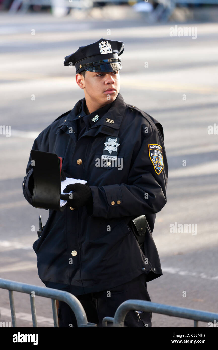 A NYPD Auxilliary Police officer takes notes while on duty at a parade ...