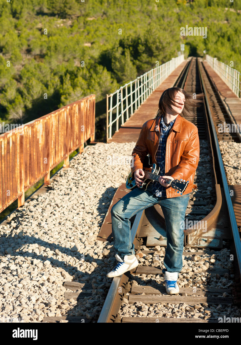 Guitarist performing on a railway bridge Stock Photo - Alamy