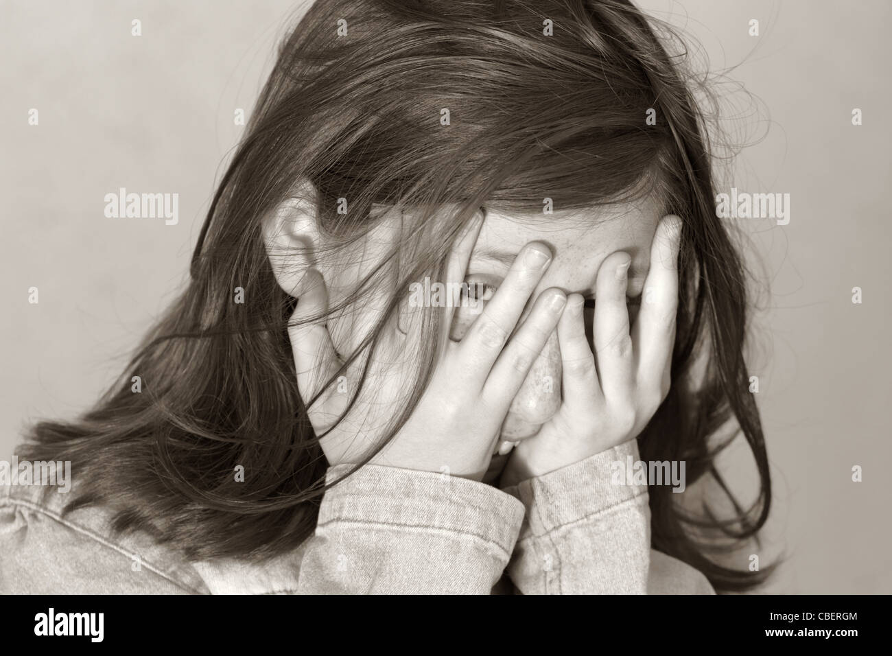 girl closing face with her hands Stock Photo - Alamy
