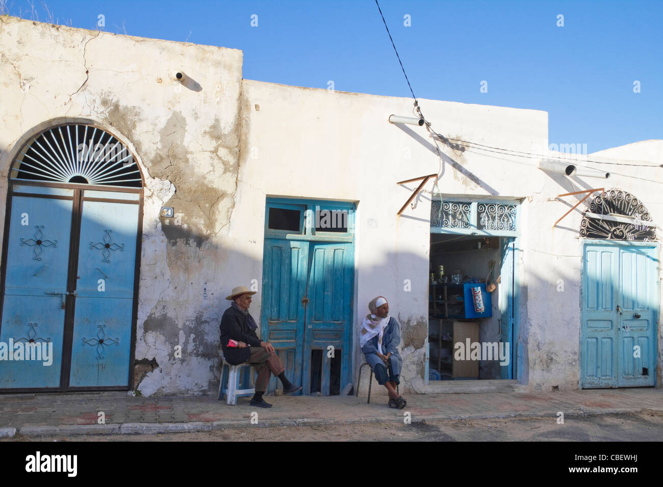 Two men resting in the Jewish quarter, Djerba island Tunisia North ...