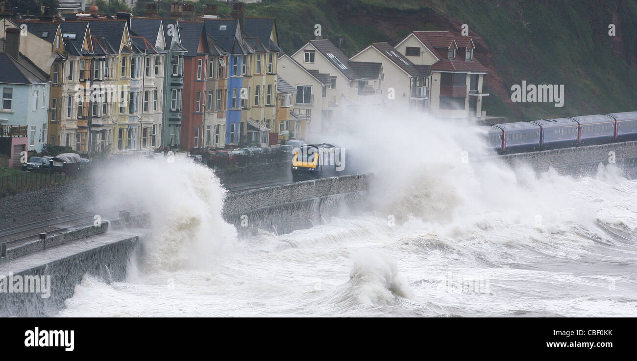 Waves crash onto a train as it heads into Dawlish station during ...