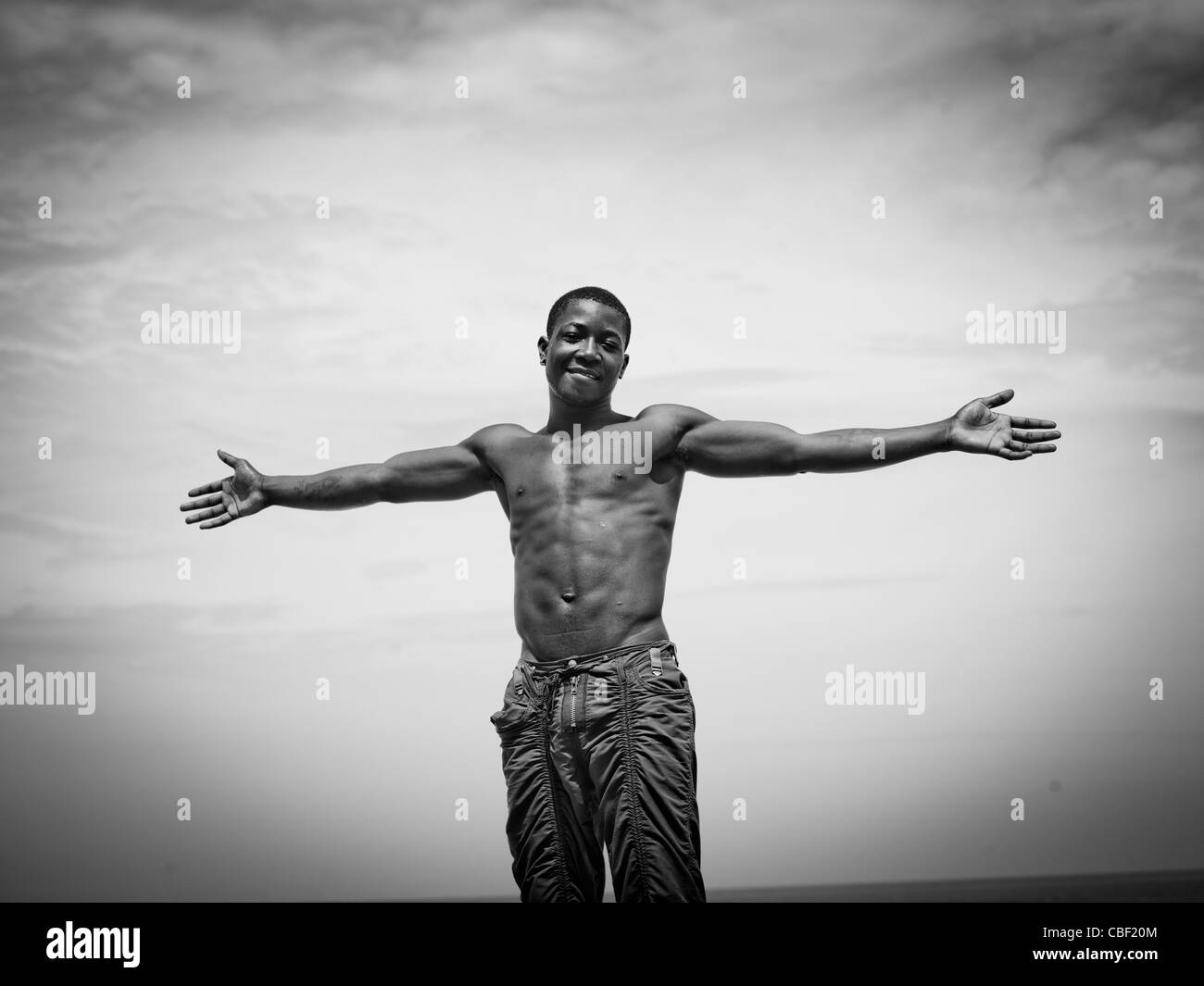 Man Doing The Christian Cross With His Arms On The beach, Benguela ...