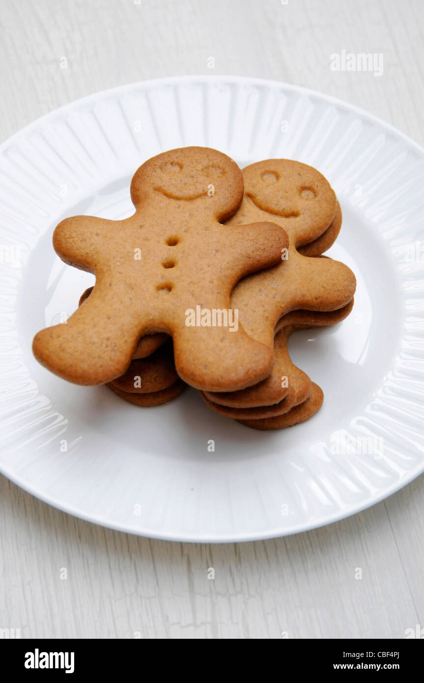Gingerbread Men Stacked on a white plate Stock Photo - Alamy