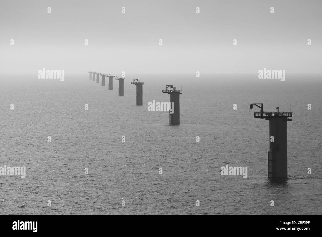 Long row of wind turbine foundations at an offshore windfarm under ...
