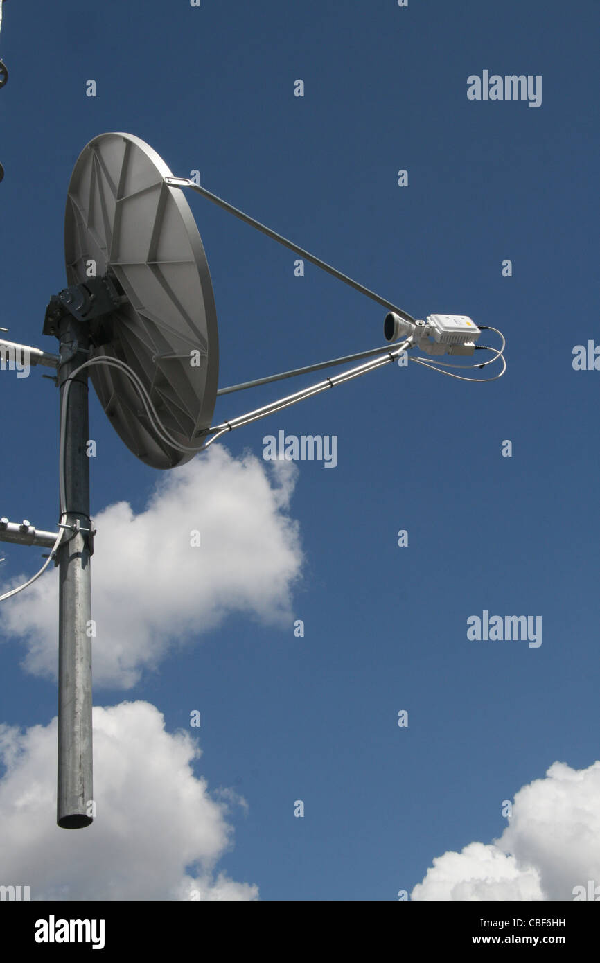 tv satellite dish transmitter receiver and blue sky Stock Photo - Alamy