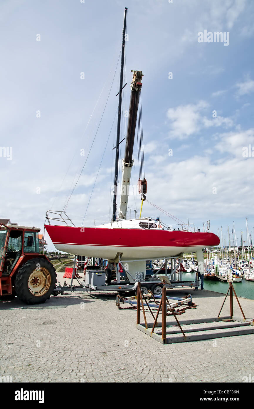 Lifting sailing boat in the water with crane in the harbor Stock Photo ...