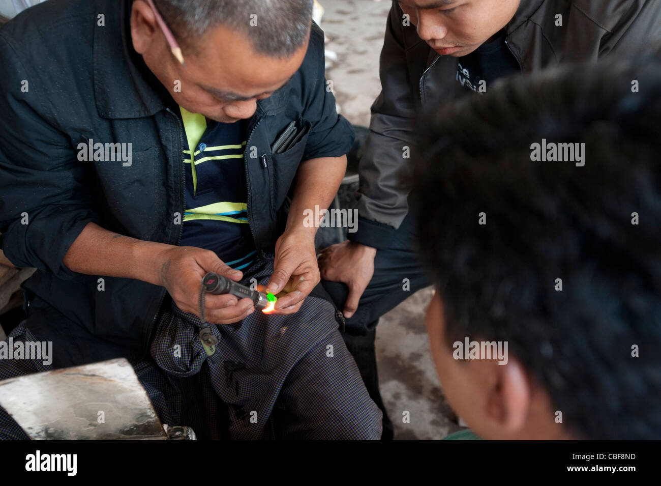 Reseller is checking jade quality with flashlight, Bogyoke Aung San ...