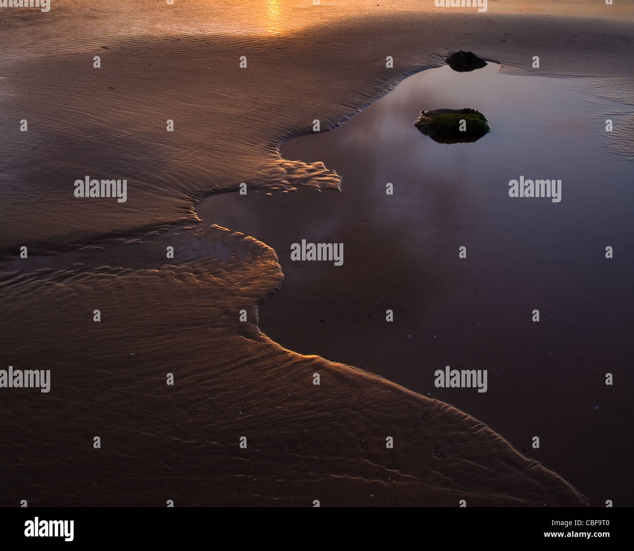 Sunset reflections, Gower, Wales Stock Photo - Alamy