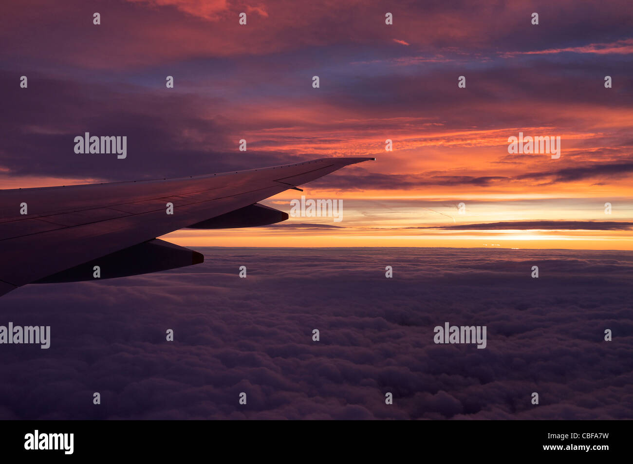 Sunrise and the wing of a 777-300ER Boeing airliner Stock Photo - Alamy