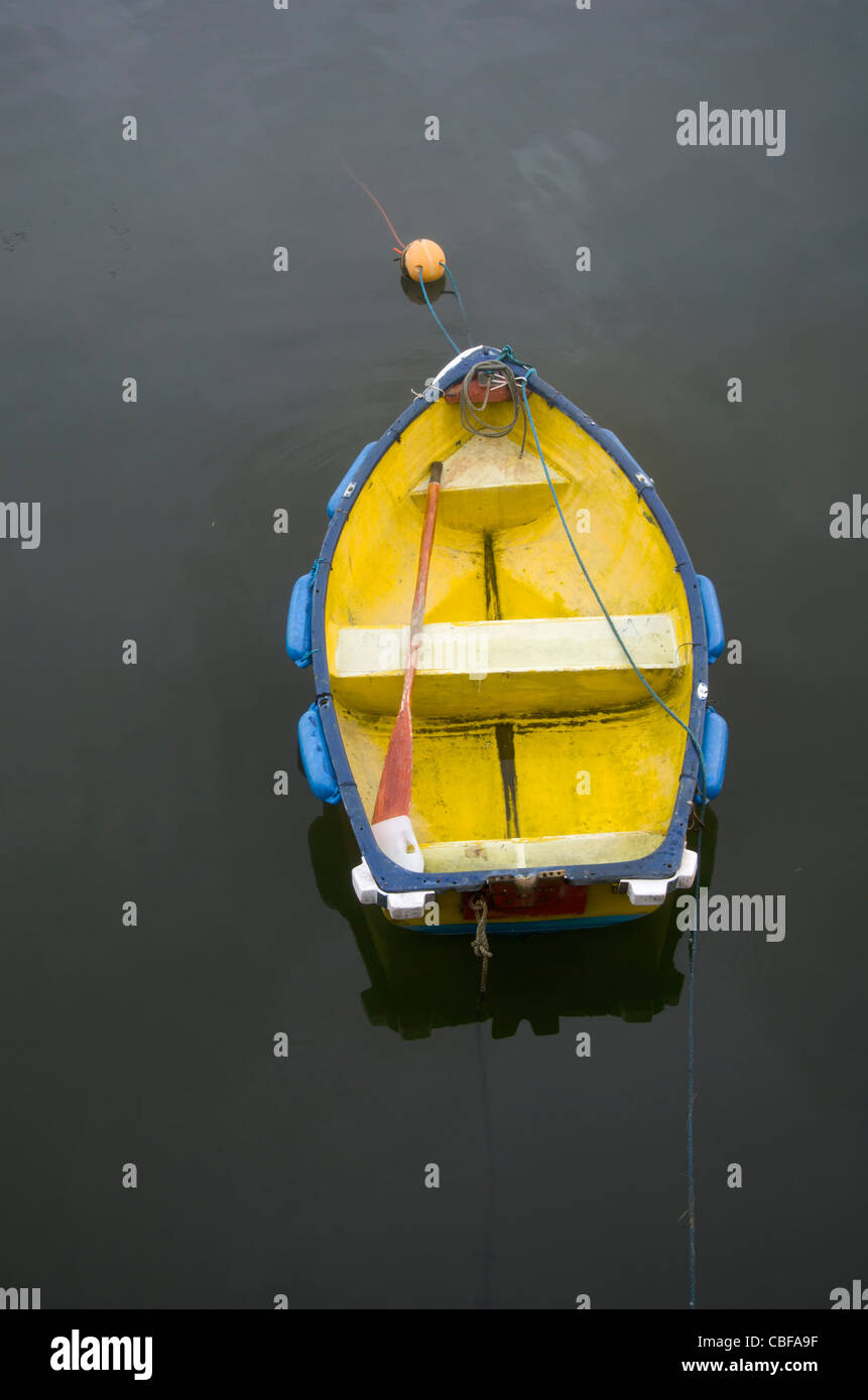 A lovely yellow dinghy moored in the harbour of Whitehaven Stock Photo ...