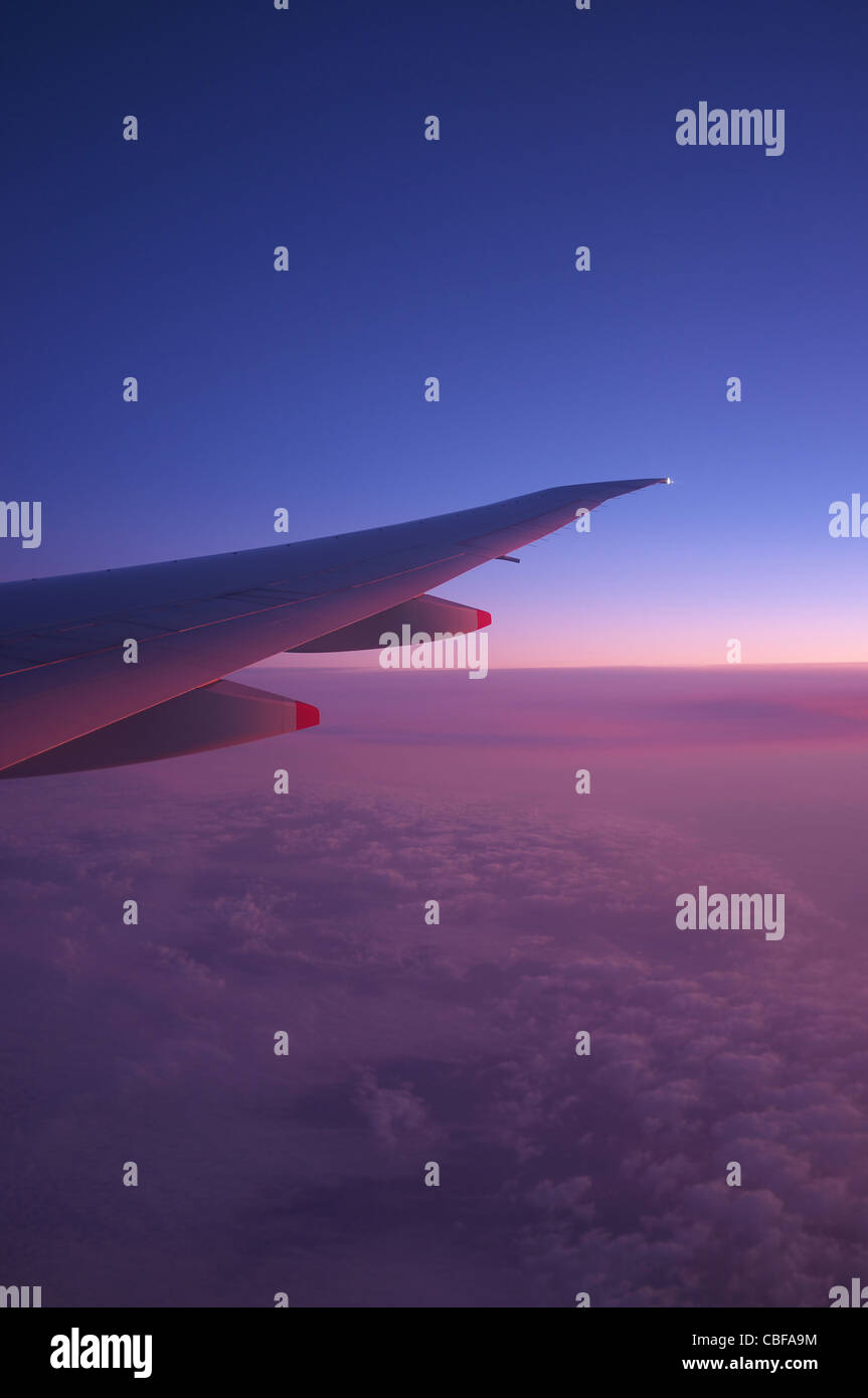 Sunrise and the wing of a 777-300ER Boeing airliner Stock Photo - Alamy