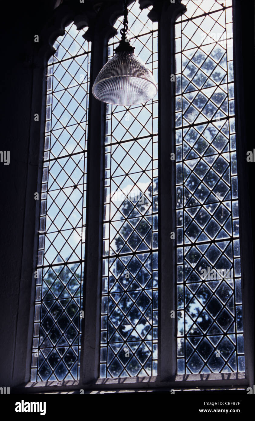 Tall Early English Gothic windows with clear diamond-leaded glass with ...