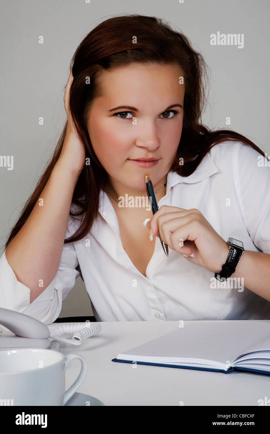young woman working away at her desk Stock Photo - Alamy