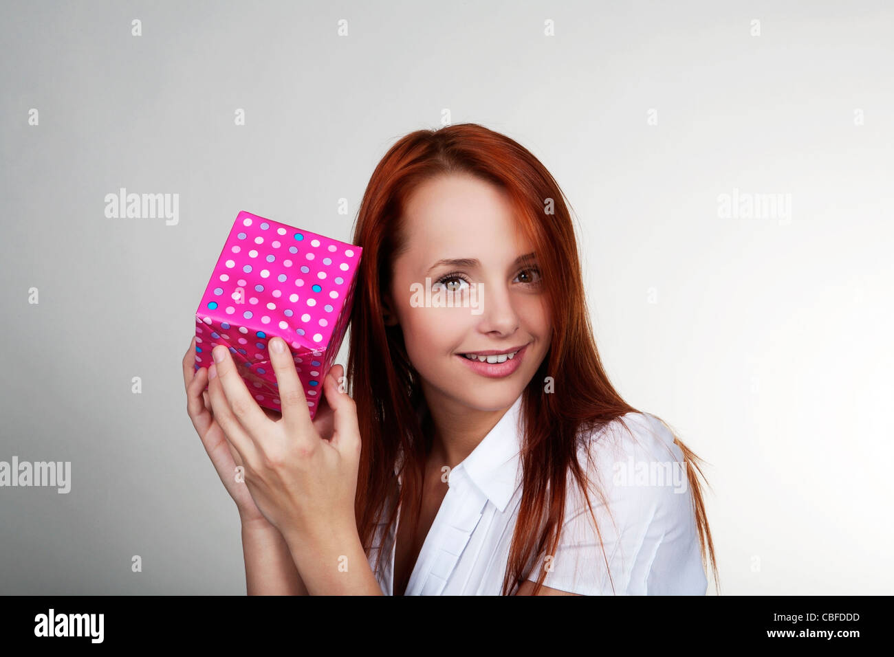 woman holding a small box wrapped up Stock Photo - Alamy