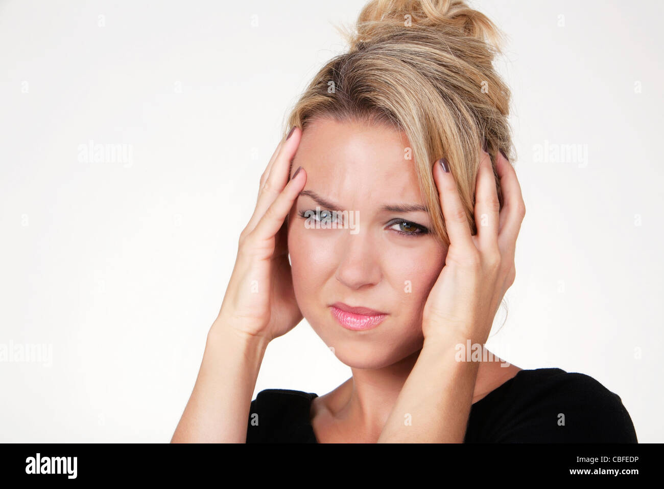 woman with a big headache shot in the studio Stock Photo - Alamy