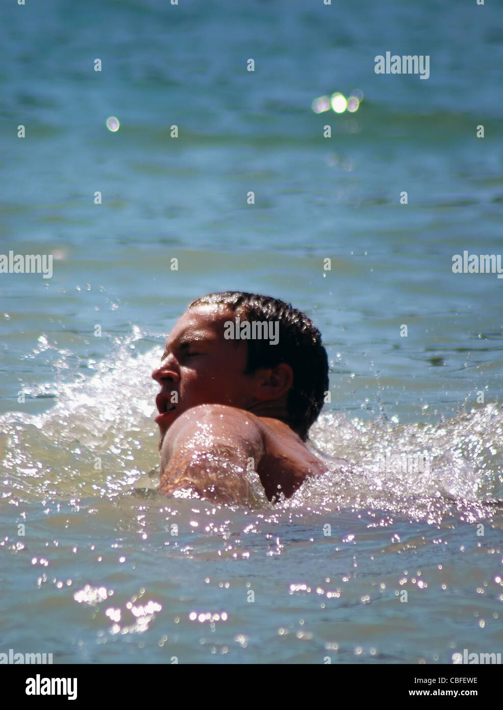 Young man swimming in a lake Stock Photo - Alamy