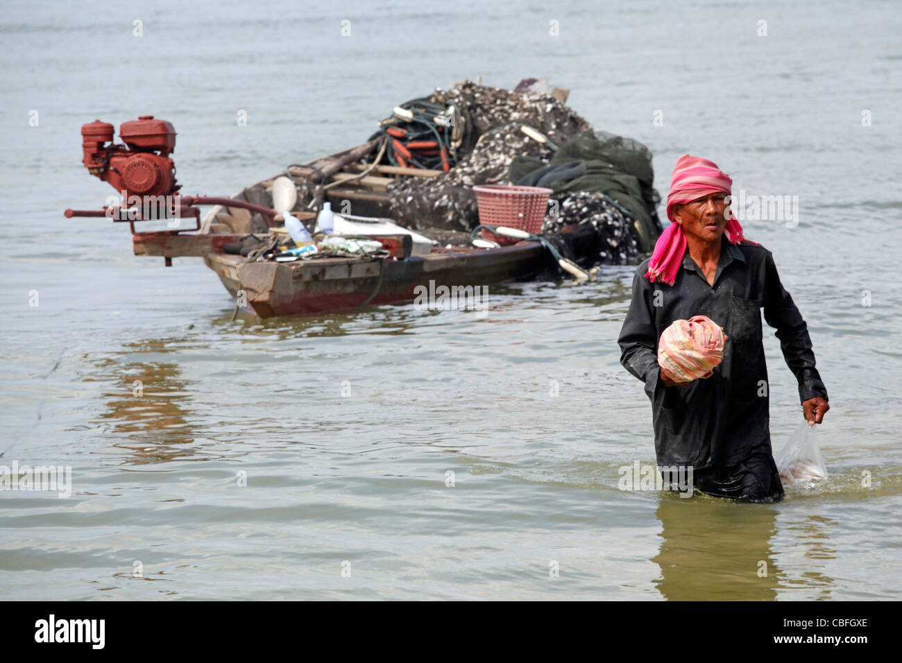 Fisherman with his catch of fish in traditional fishing boat hi-res ...