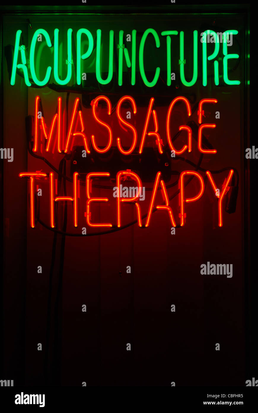Neon sign advertising acupuncture and massage therapy Stock Photo - Alamy