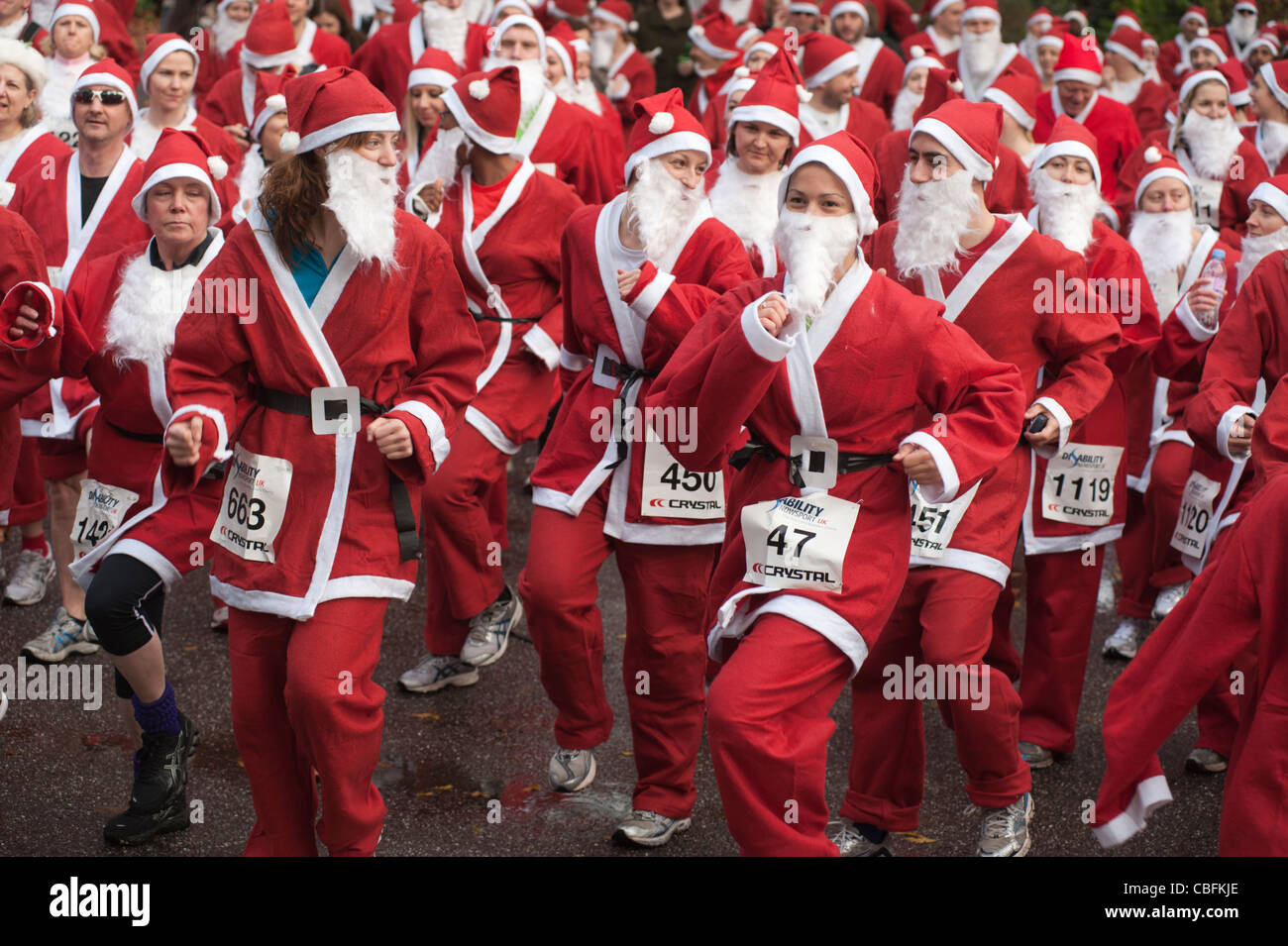 Runners in Santa Claus fancy dress warming up before the annual Santa ...