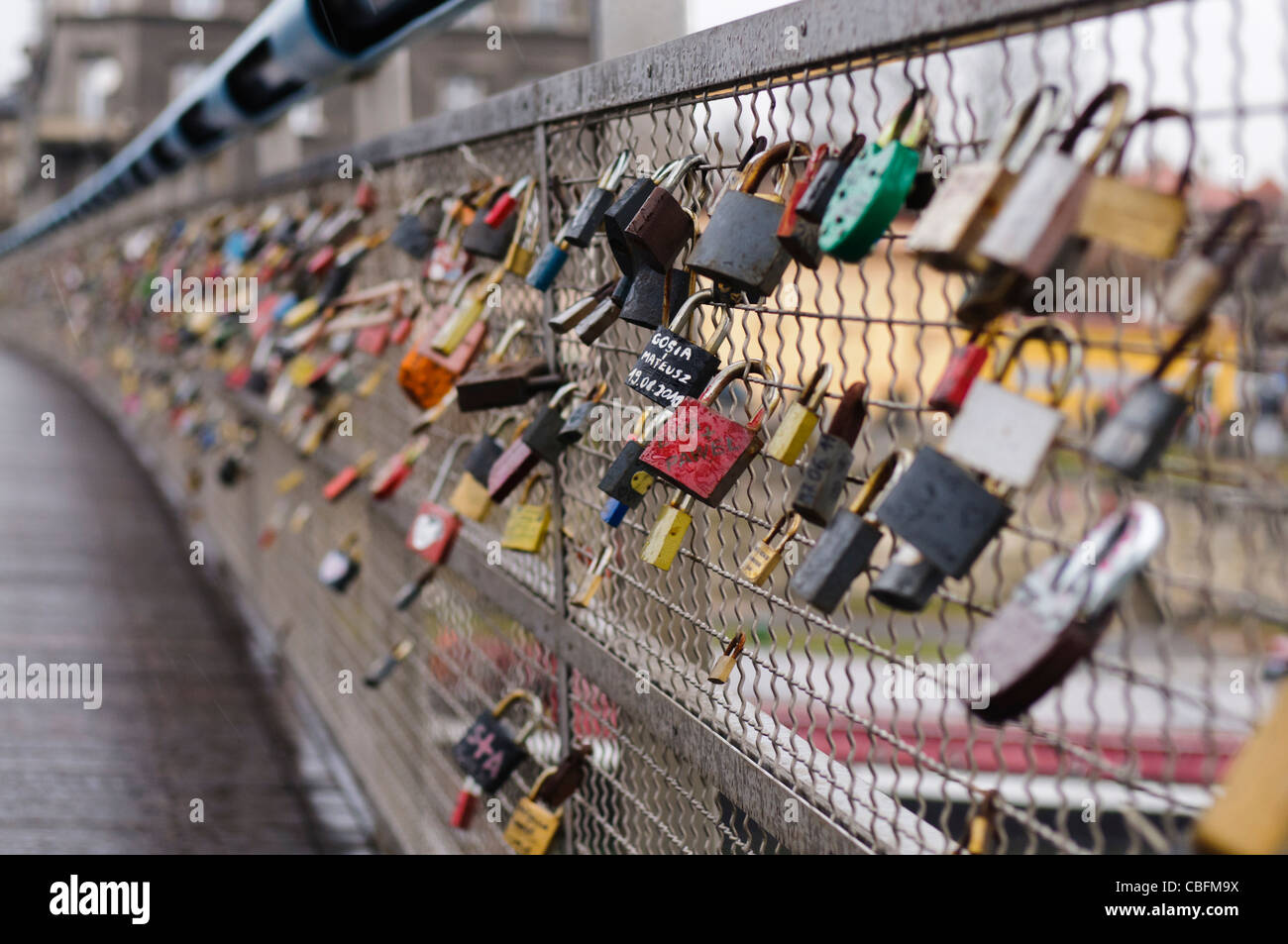 Locks with names of lovers attached to a bridge over the River Vistula ...