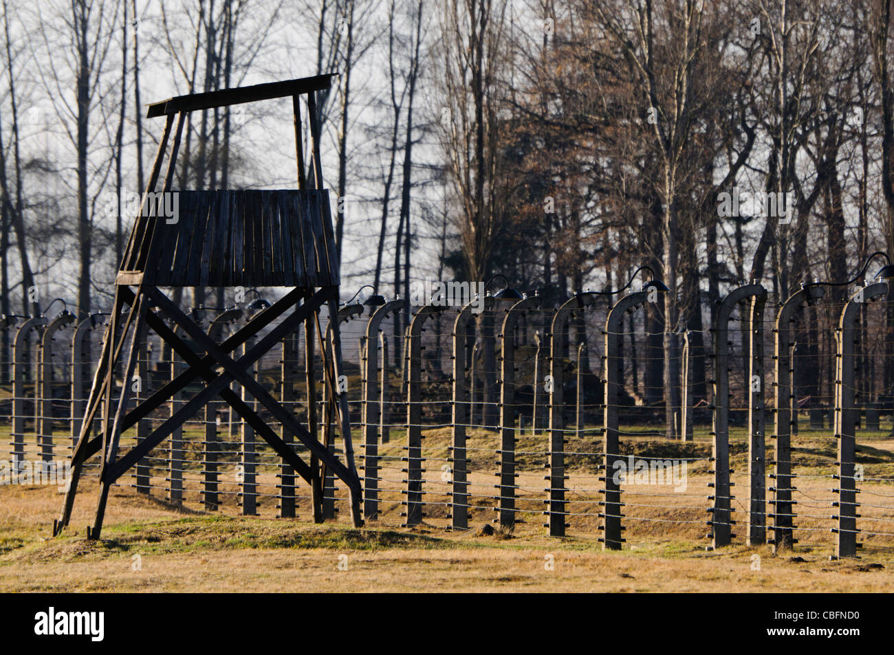 Watchtower beside electrified barbed wire security fence at Auschwitz ...