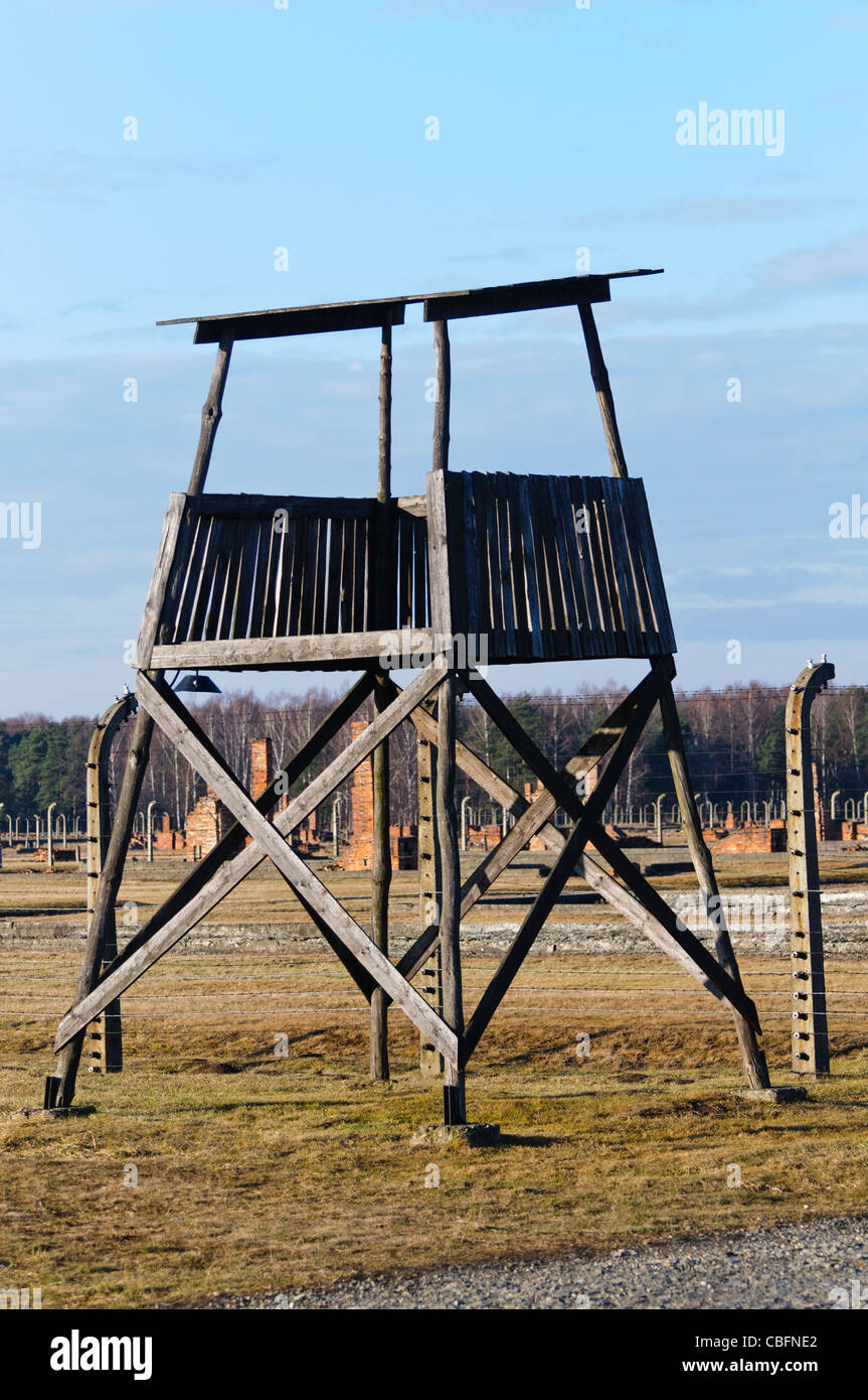Watchtower beside electrified barbed wire security fence at Auschwitz ...