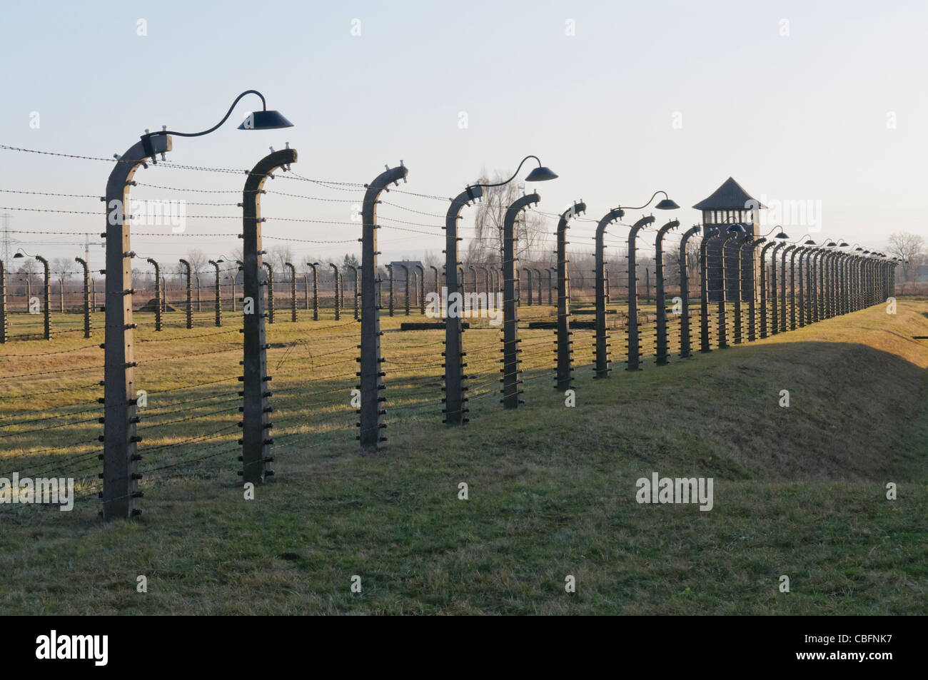 Watchtower beside electrified barbed wire security fence at Auschwitz ...