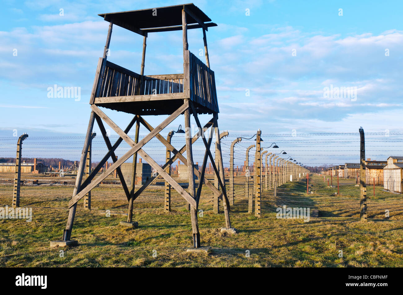 Watchtower beside electrified barbed wire security fence at Auschwitz ...